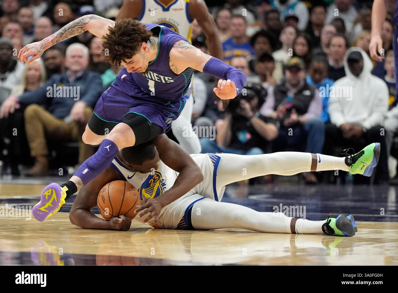Charlotte Hornets guard LaMelo Ball chases a loose ball with Golden ...