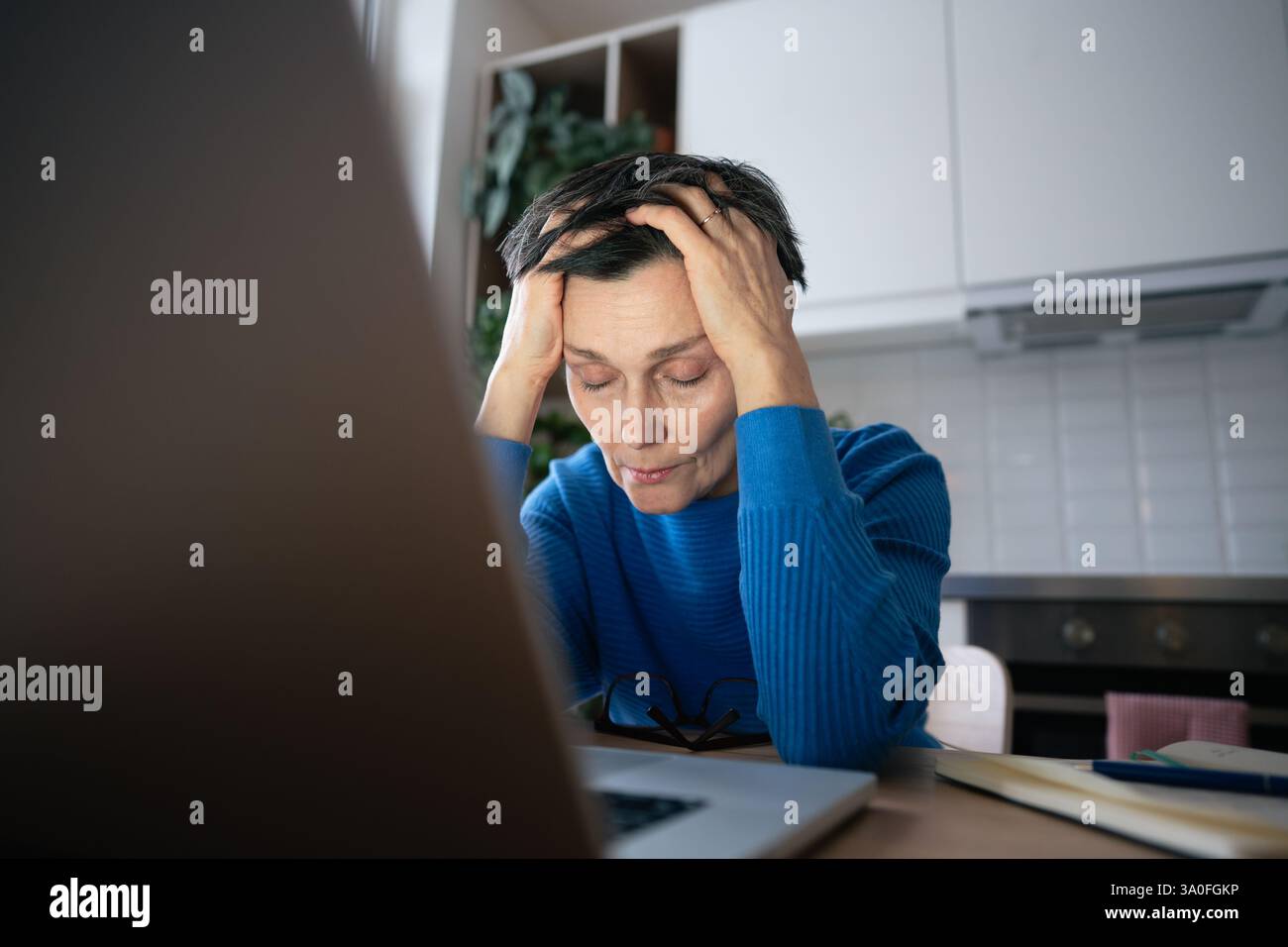 Burnout woman. Fatigued female slumped near laptop, battling eye strain ...