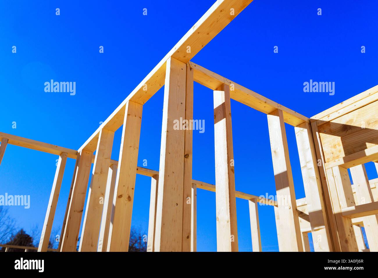 Construction workers are erecting wood framing for new building during ...