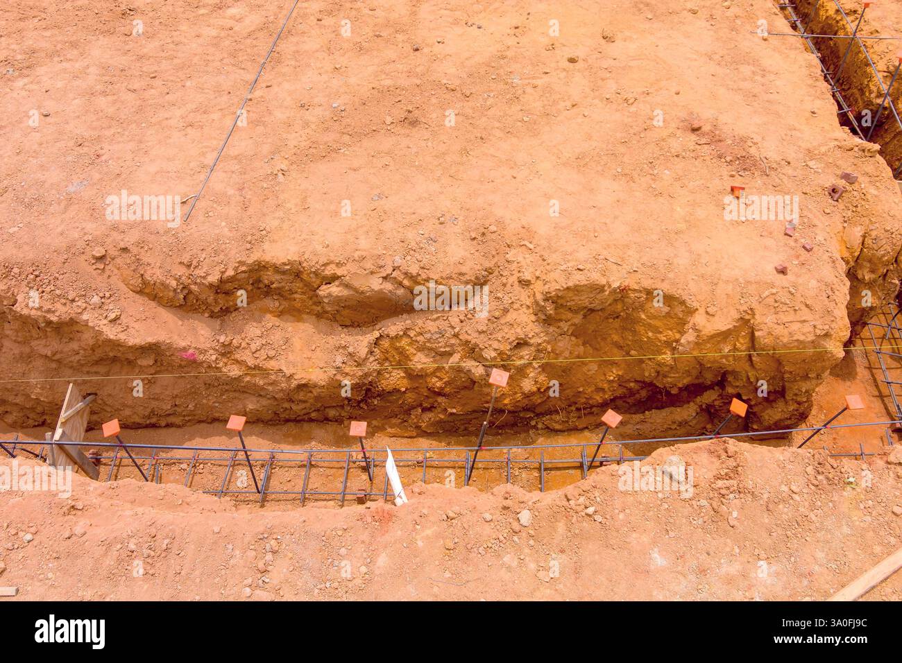 Are setting foundations placing rebar in construction site surrounded by dirt Stock Photo - Alamy