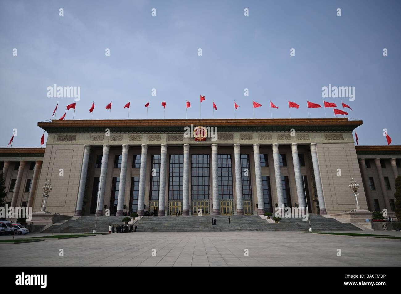Peking, China. 04th Mar, 2025. Red flags fly at the Great Hall of the ...