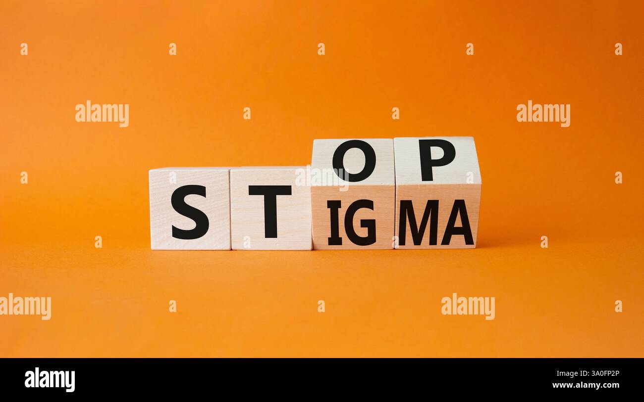 Stop and Stigma symbol. Businessman hand points at wooden cubes with ...