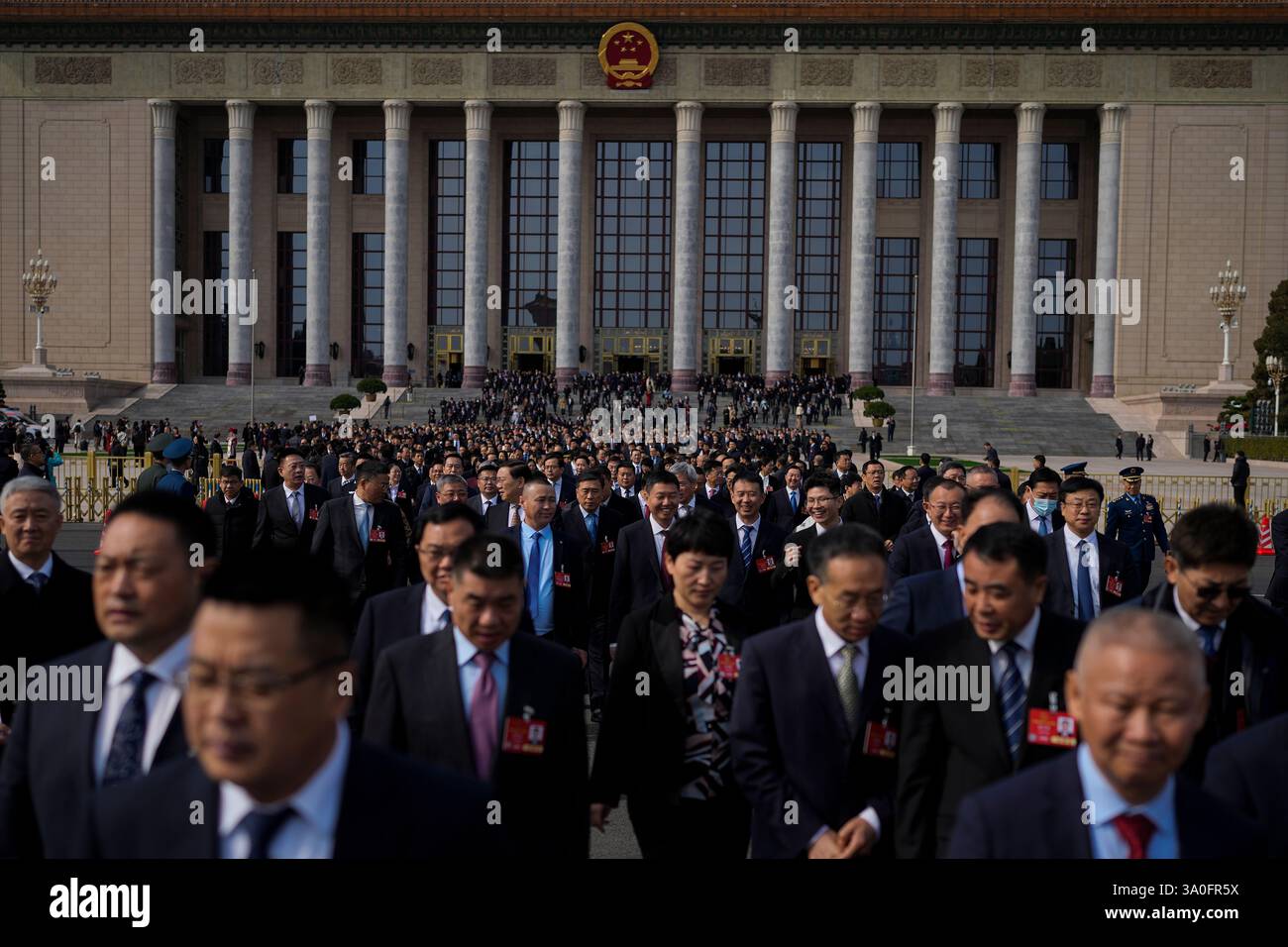 Delegates leave the Great Hall of the People after attending a ...