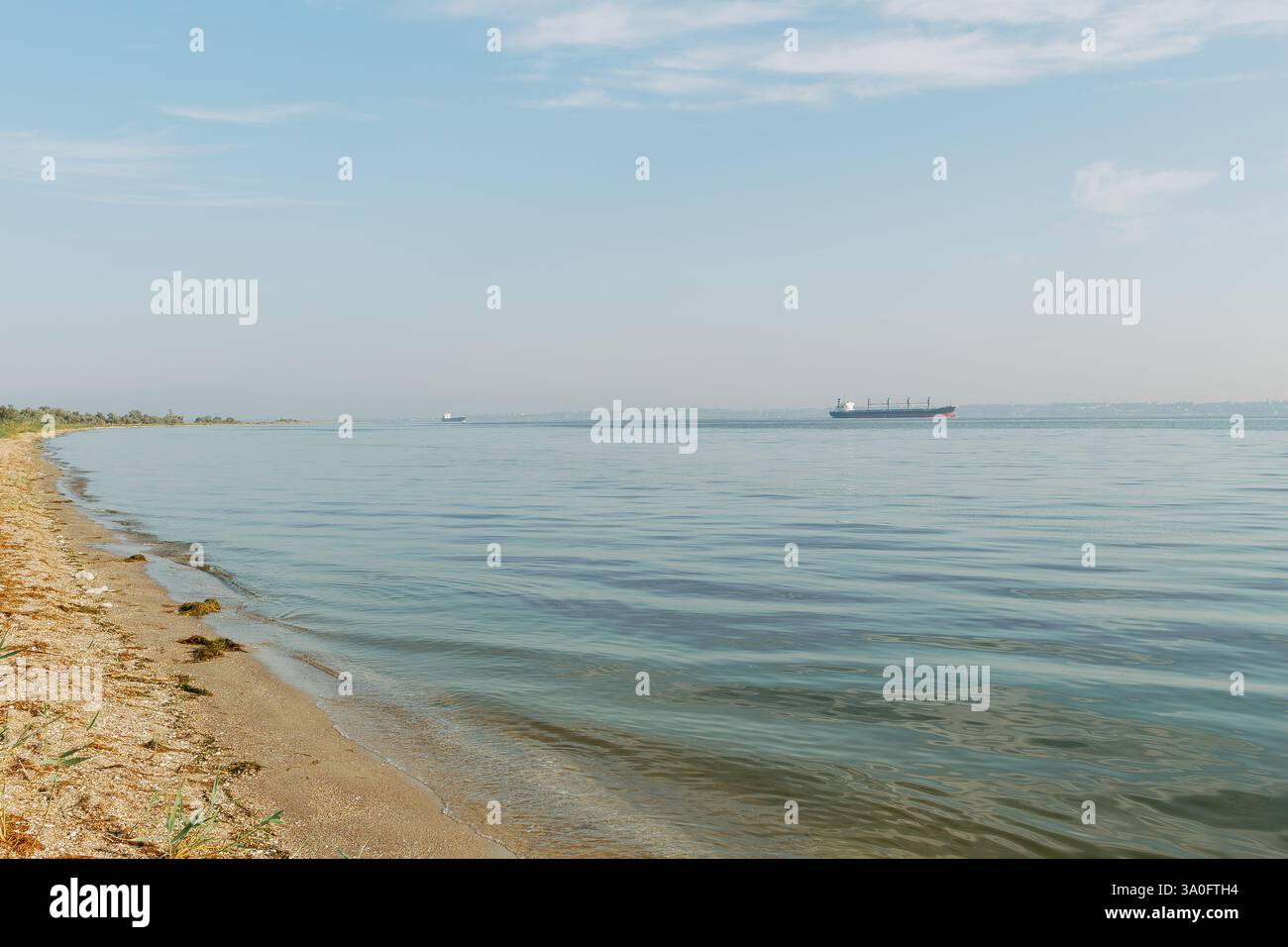 A peaceful beach with gentle waves lapping the shore, overlooking a ...