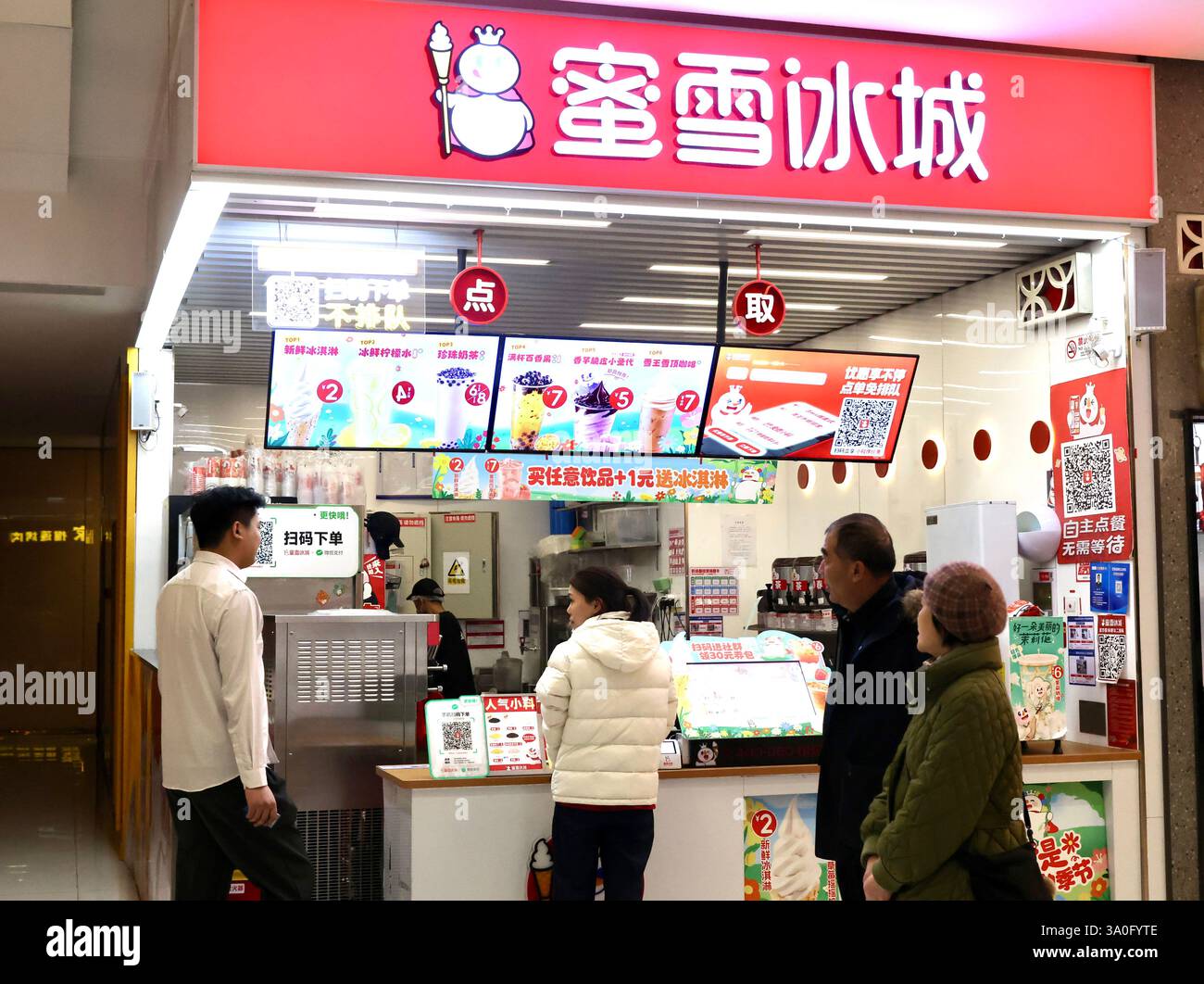 Hong Kong,China.3rd March 2025. Consumers buy beverages outside a Mixue ...