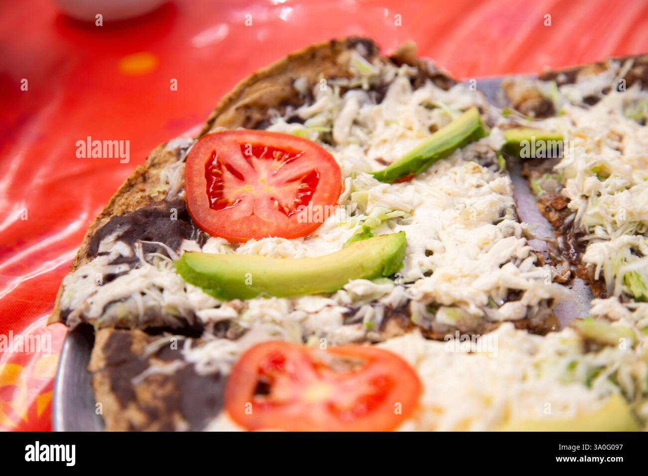 Tlayuda is a thin, crispy tortilla topped with black beans, beef jerky ...