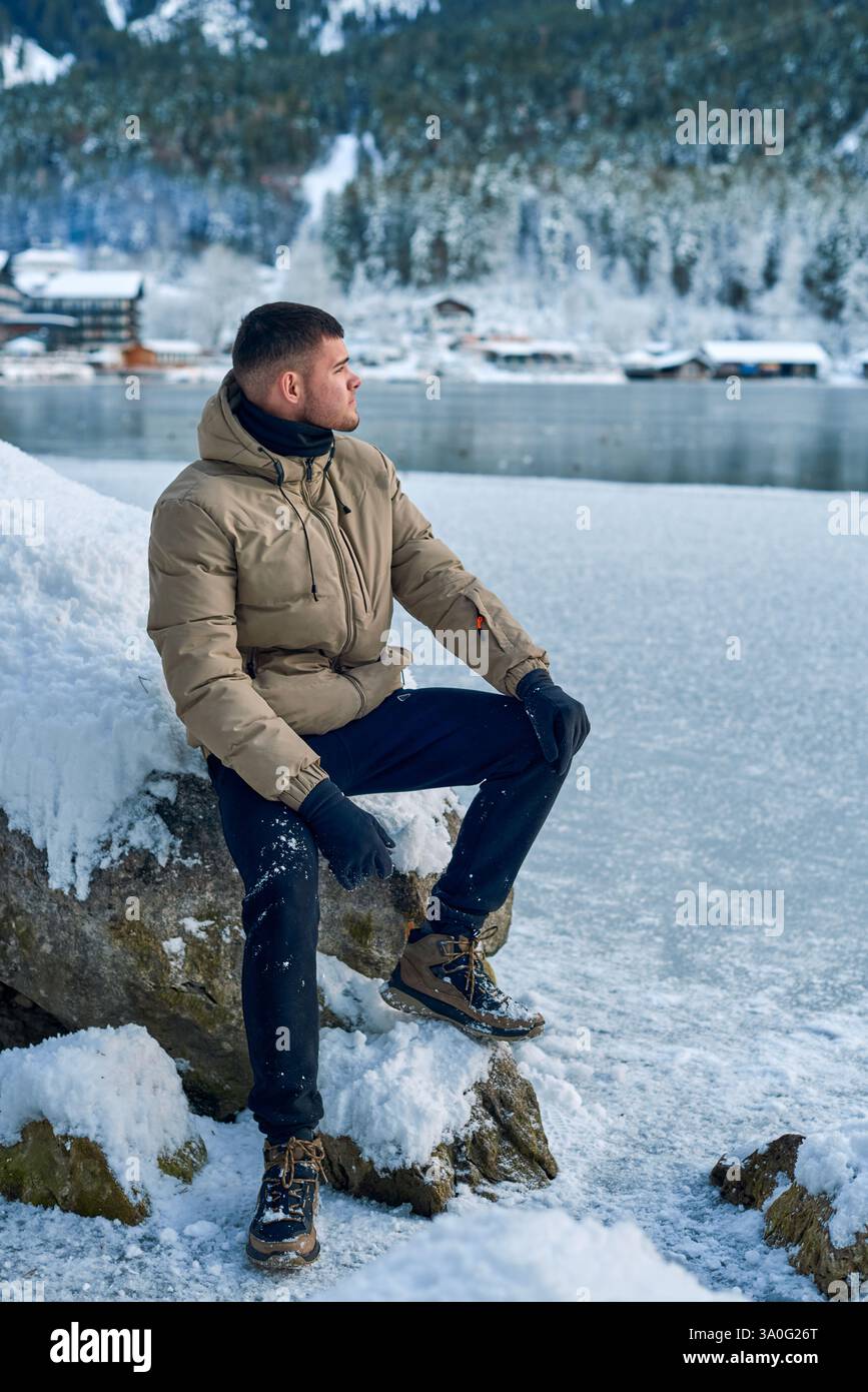 This captivating winter scene showcases a young man in his early 20s ...