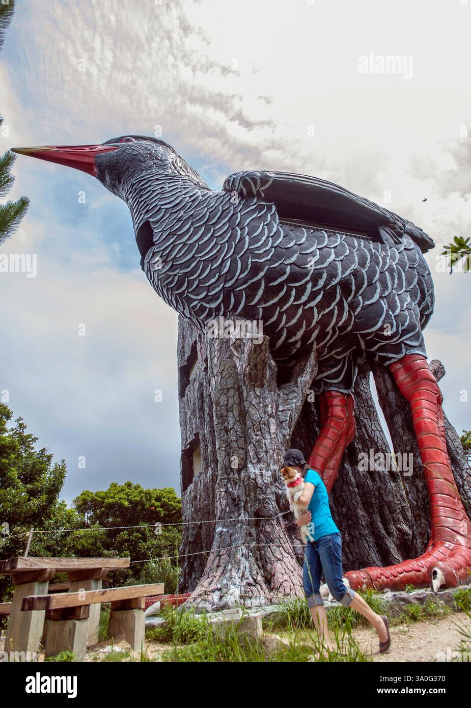 A visitor walks past an observation tower resembling a giant Yanbaru ...