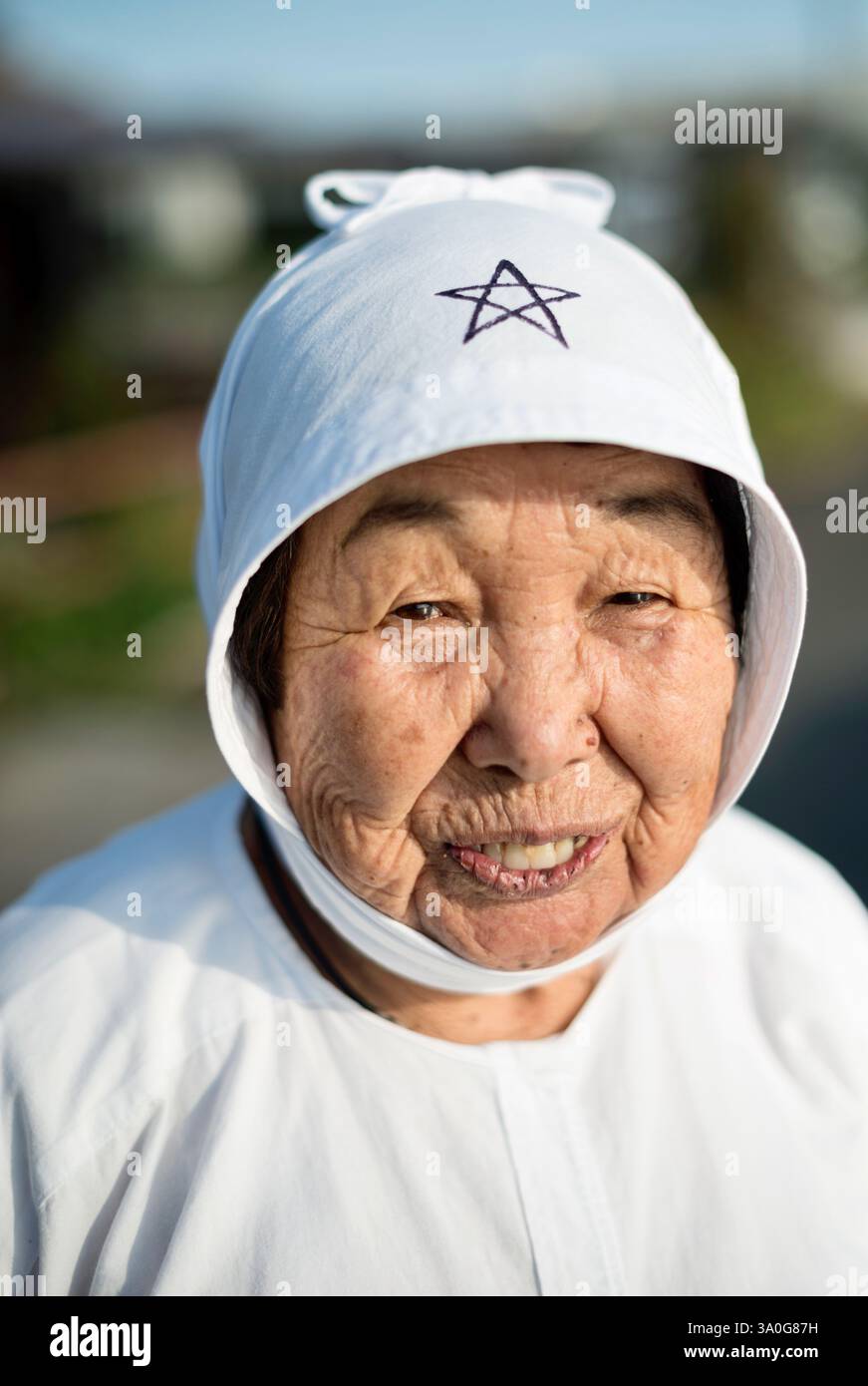 Reiko Nomura poses for a photo outside the Hachimankamado hut, which ...