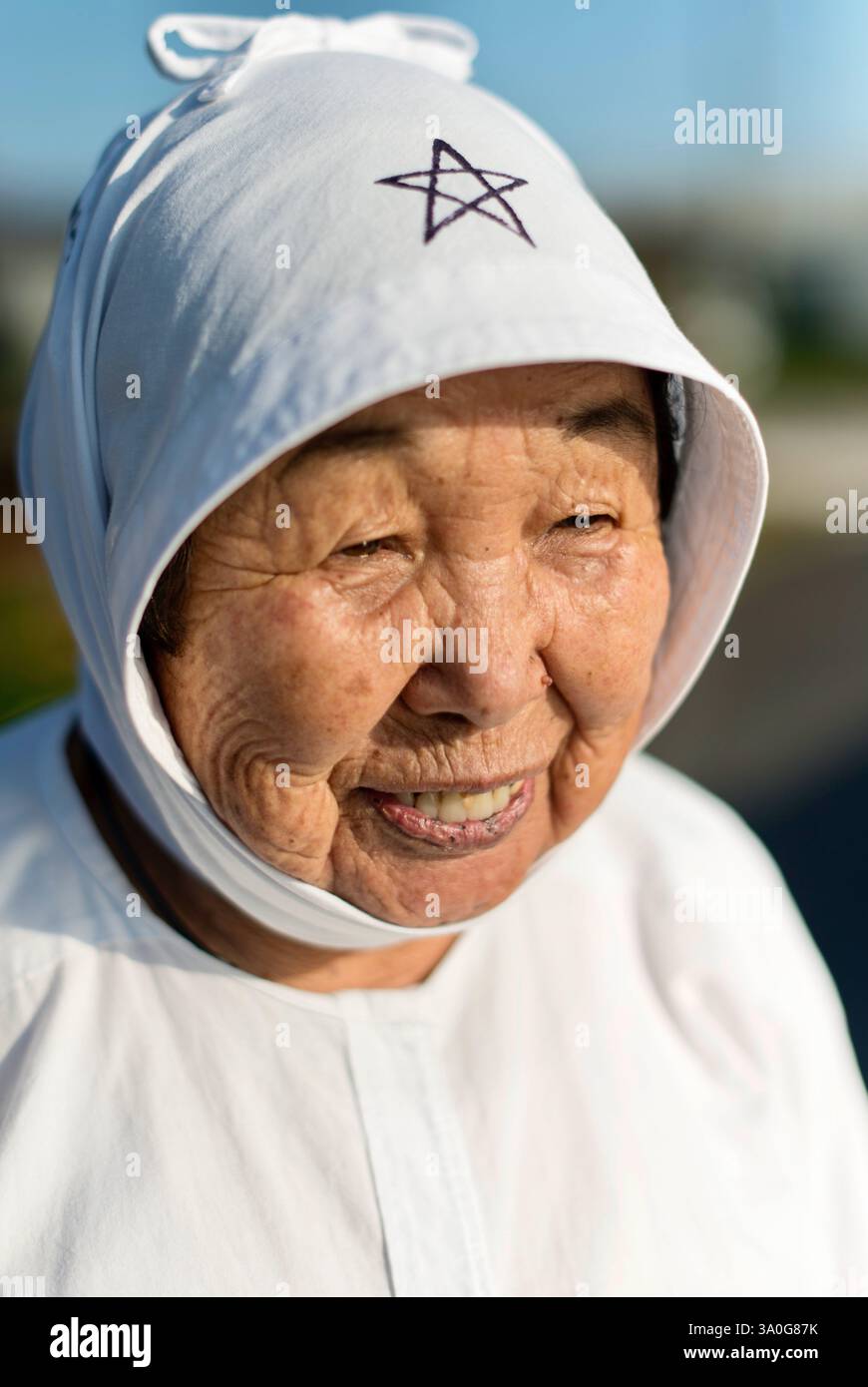 Reiko Nomura poses for a photo outside the Hachimankamado hut, which ...