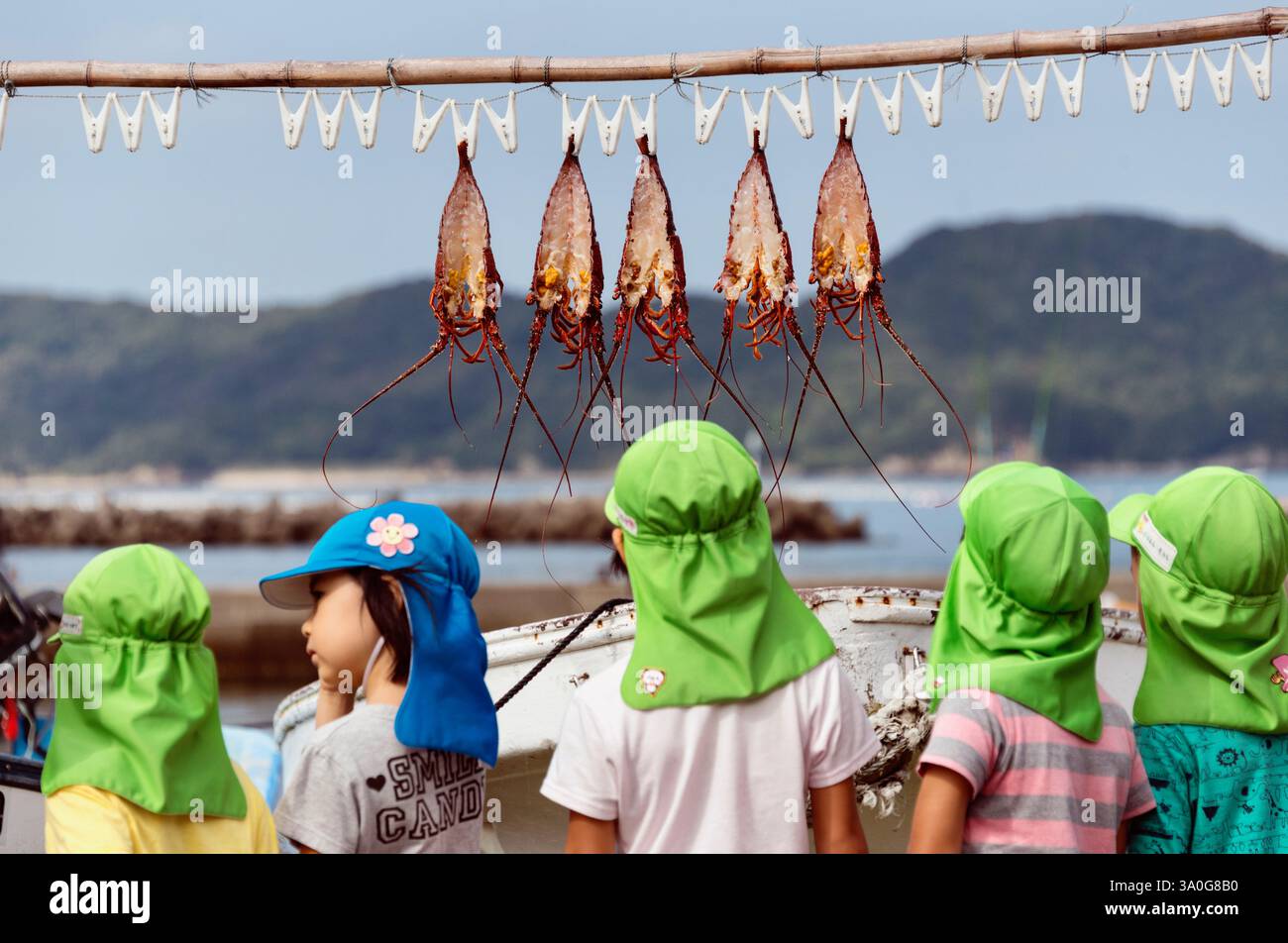 Kindergarten children look at Ise-ebi (Japanese spiny lobster) hanging ...