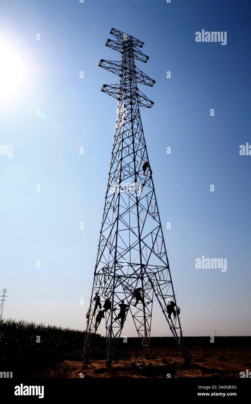 The workers of the pylon Stock Photo - Alamy