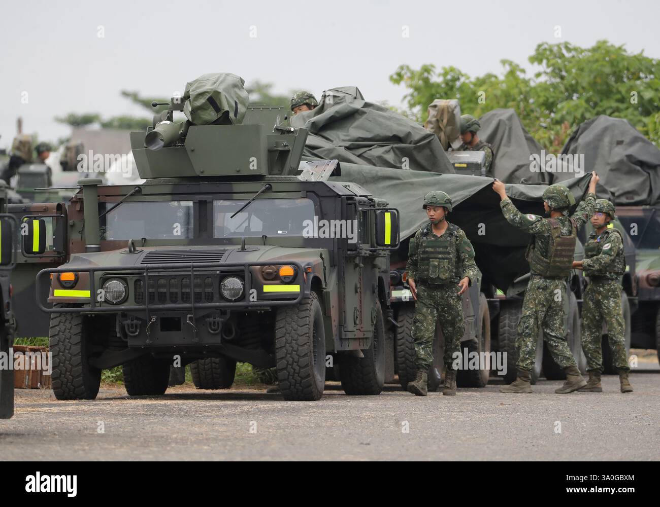FILE - Soldiers cover M1167 HMMWV (High Mobility Multipurpose Wheeled ...