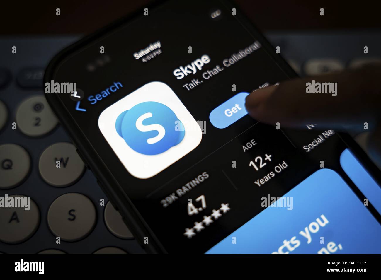 In this photo illustration, a person holds a mobile phone displaying ...