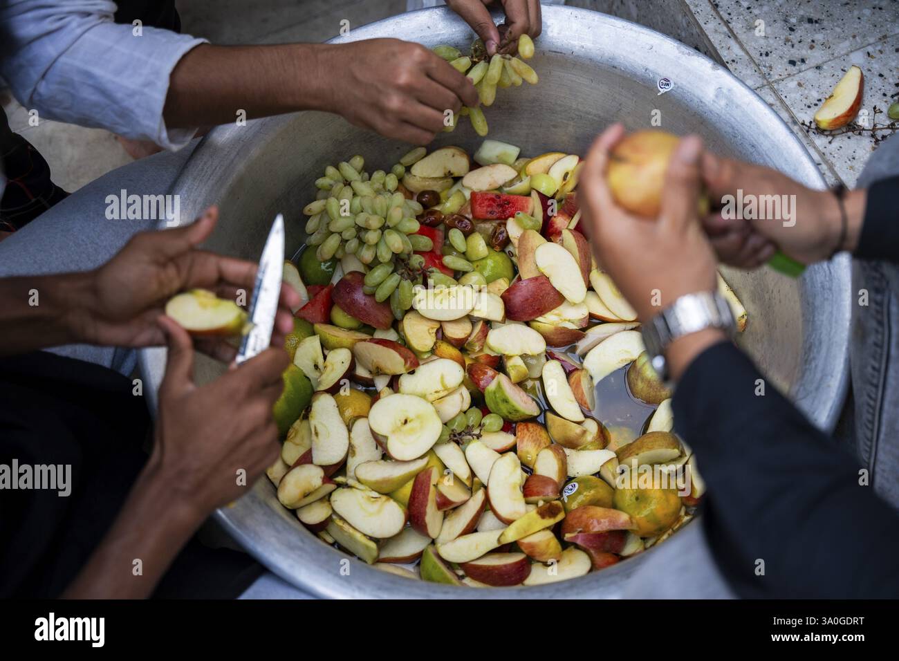 GUWAHATI, INDIA - MARCH 2: Muslim men prepare fruits at a mosque for ...