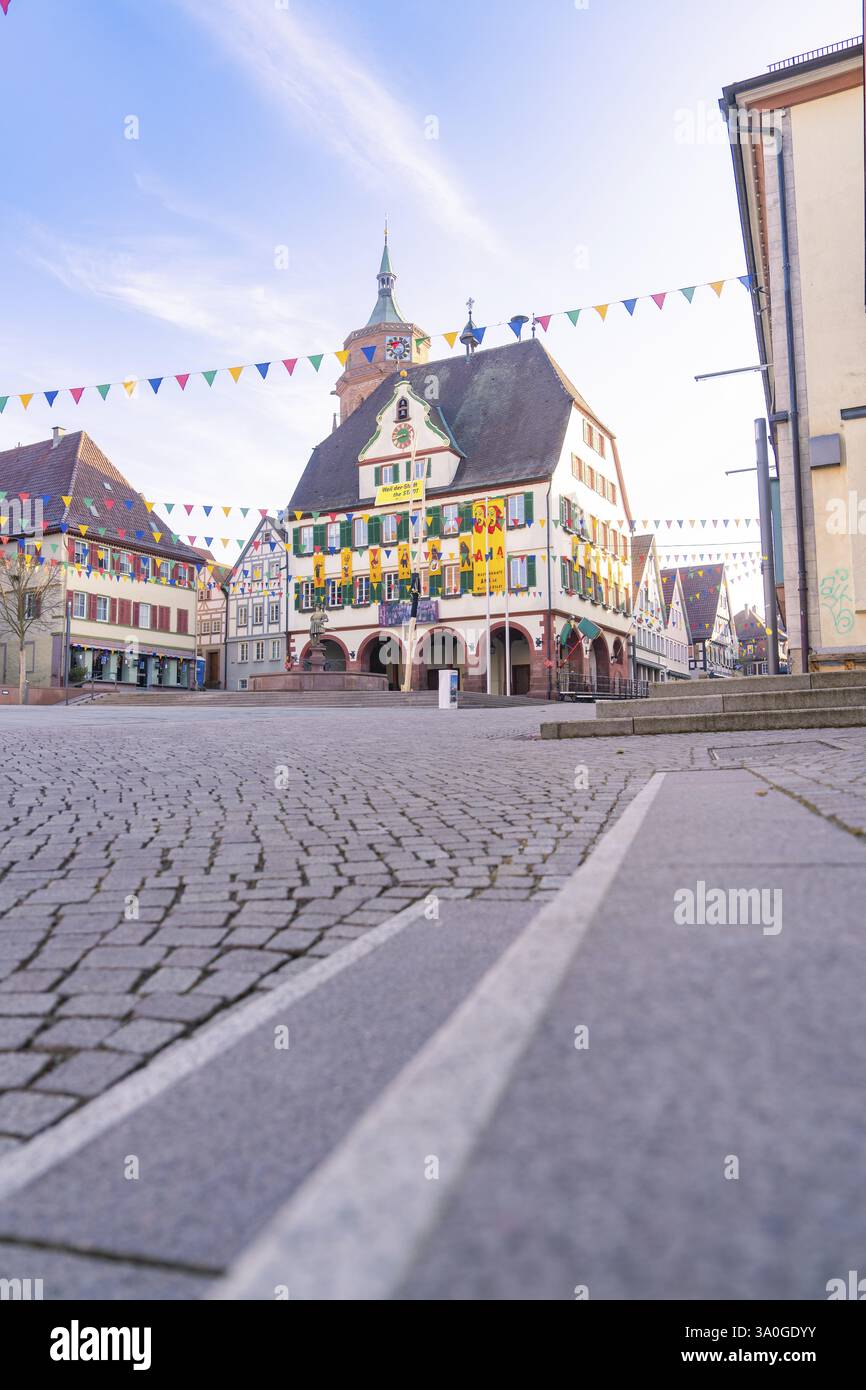 Historic town view with colourful flags and festive flair under a clear ...