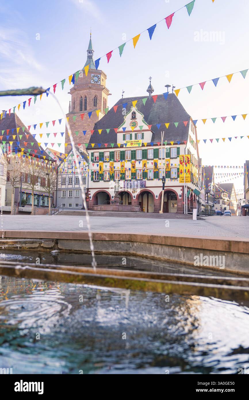 Historic town centre with fountain and festive decorations under a ...
