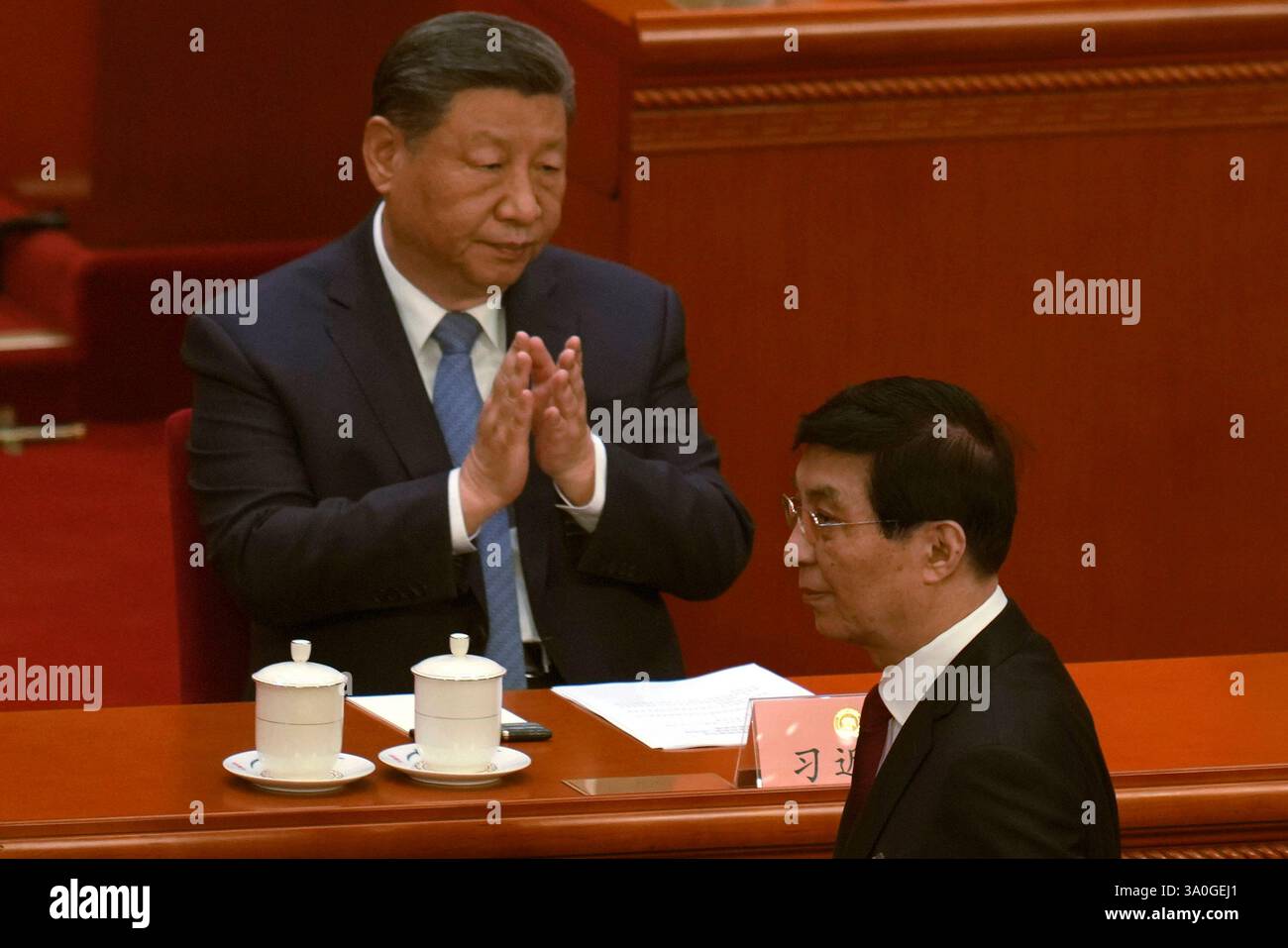 Chinese President Xi Jinping, left, applauds as Wang Huning, chairman ...