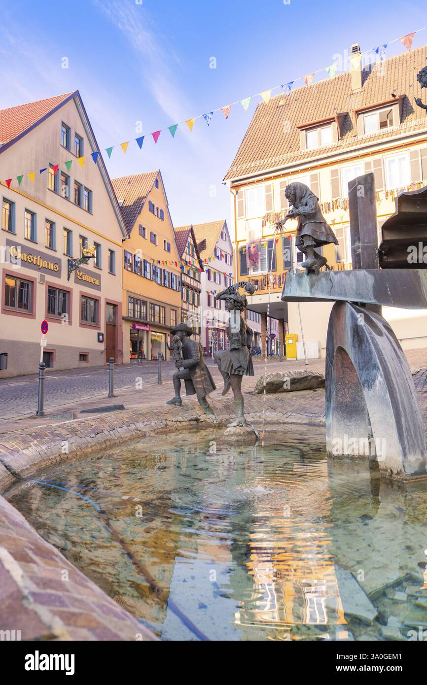 A fountain with figures on a town square, surrounded by historic ...
