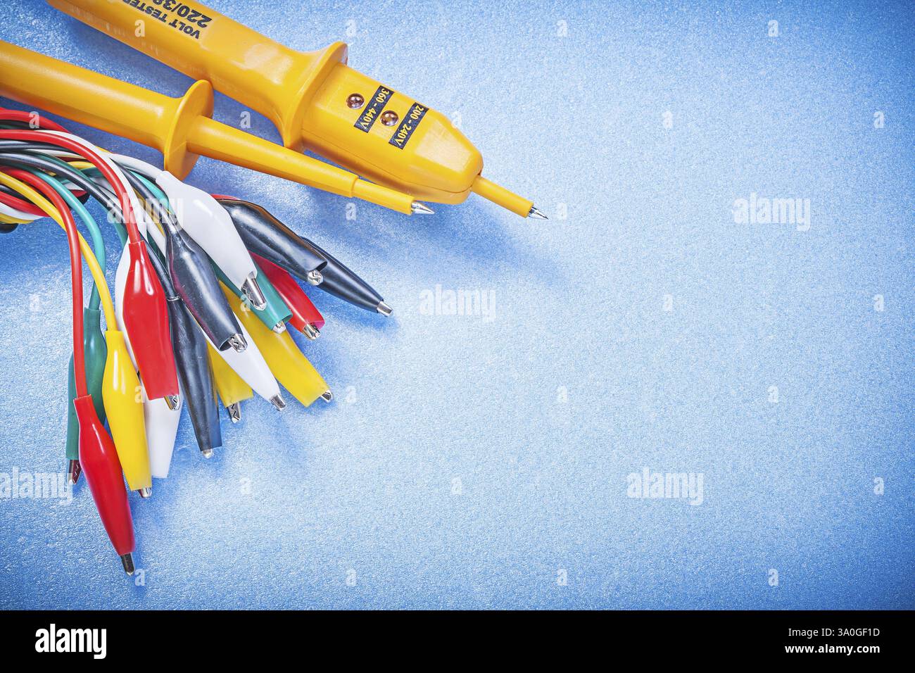 Electric tester crocodile clip cables on blue background electricity ...