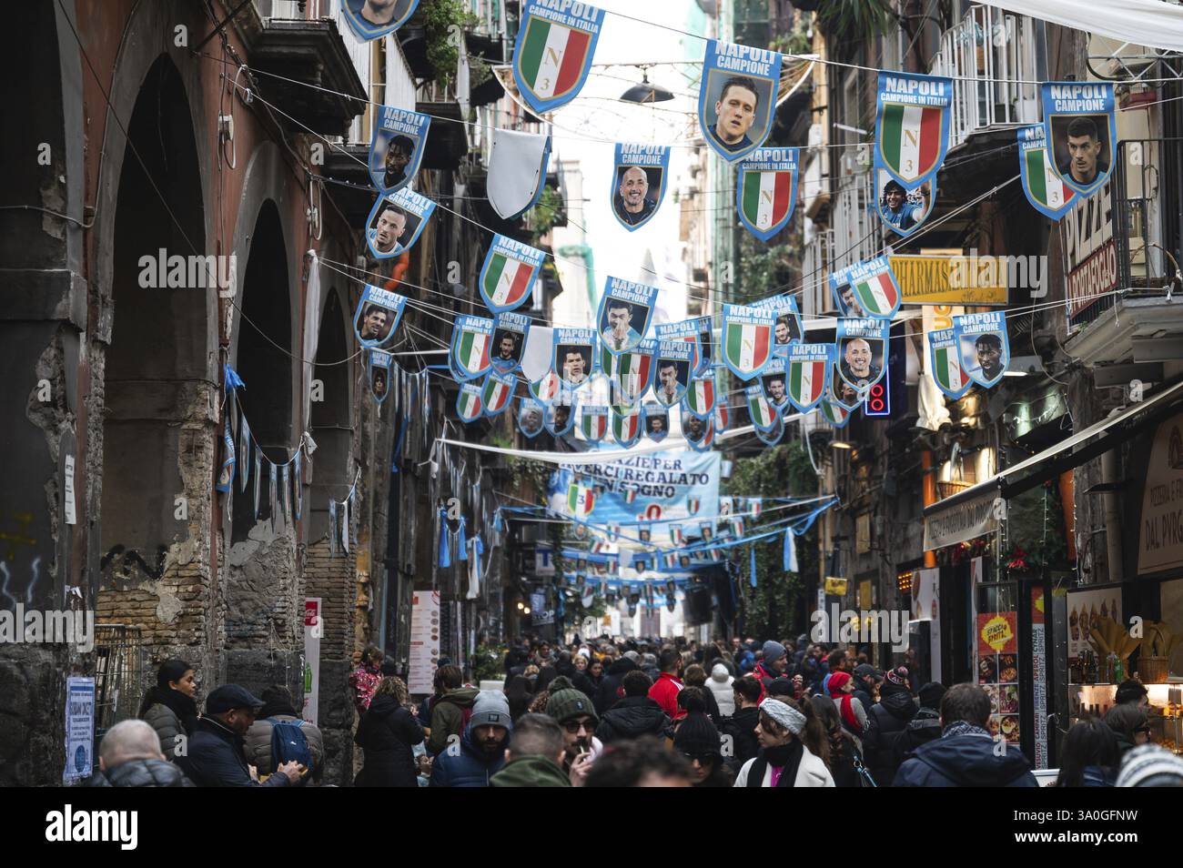 NAPLES, ITALY - JANUARY 14, 2024: A street with the pennants of the ...