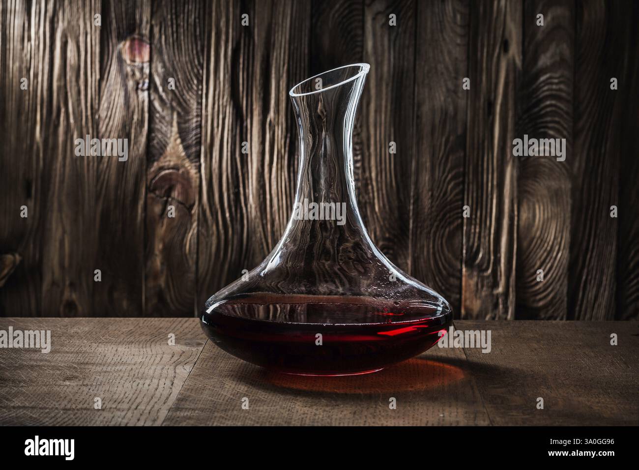 Decanter with red wine on vintage background Stock Photo - Alamy