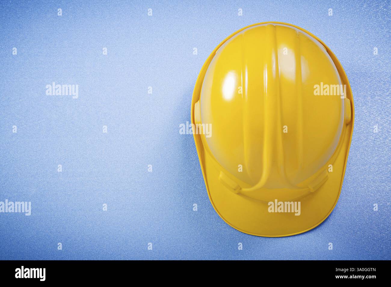 Building helmet on blue background construction concept Stock Photo - Alamy