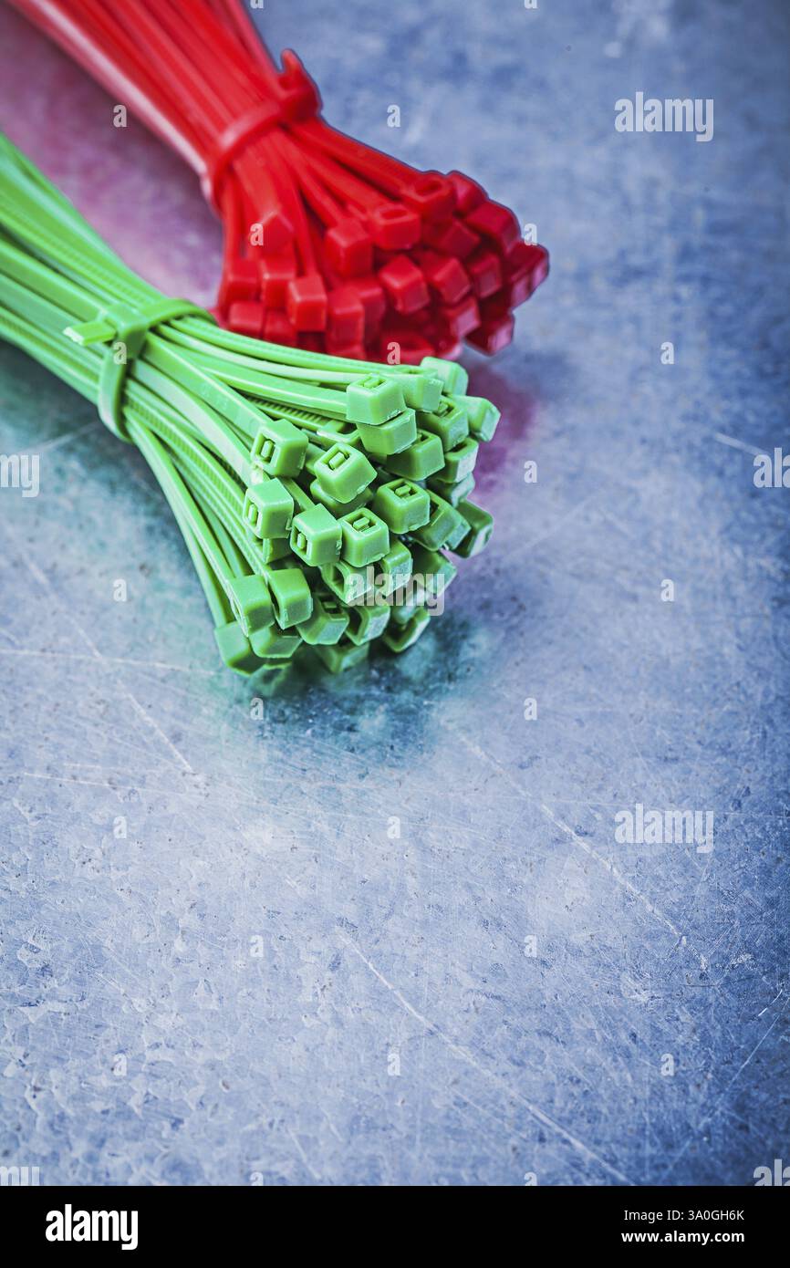 Bundle of cable ties on scratched metallic background construction ...