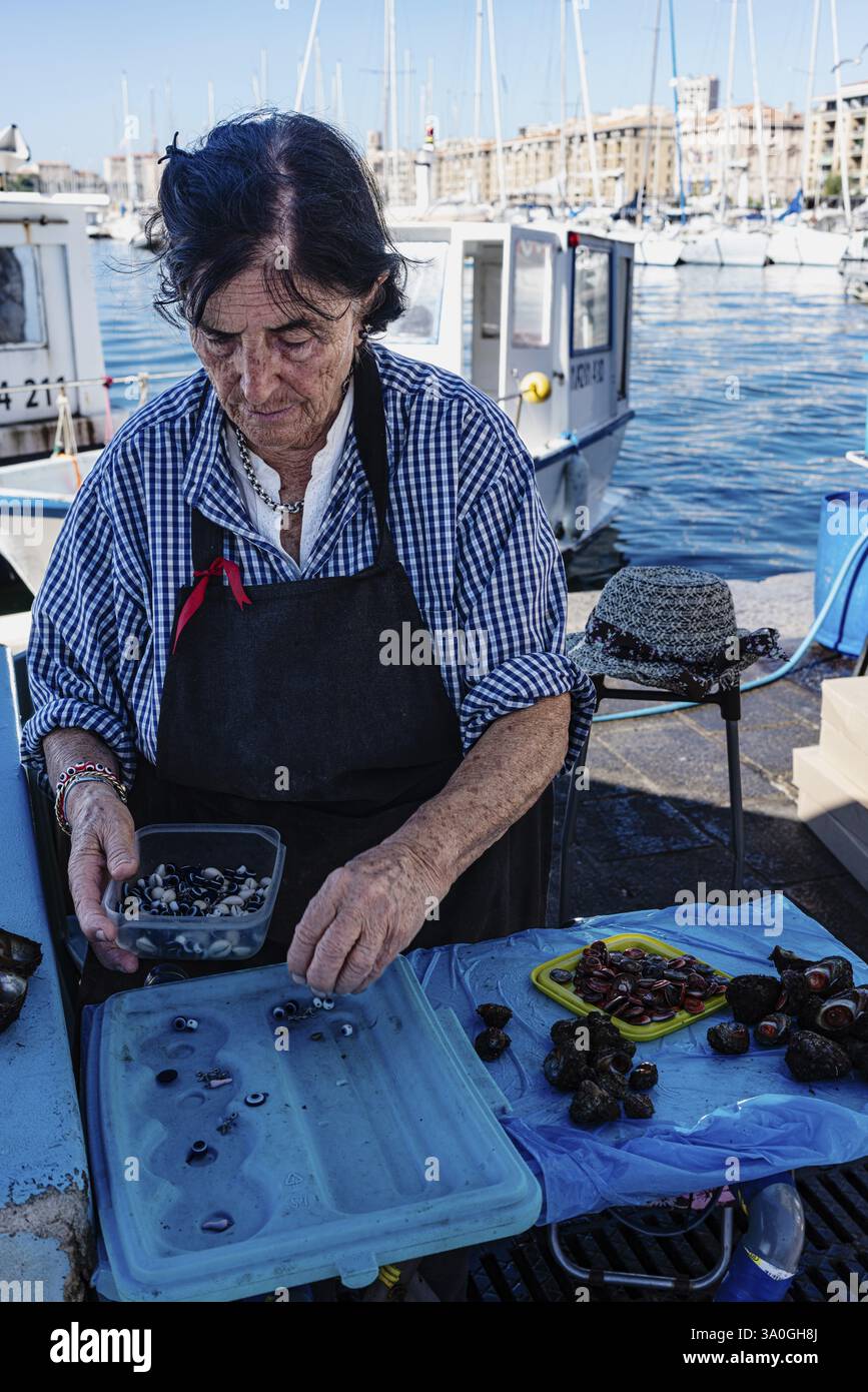 Woman selling lucky charms, otoliths of fish, at the fish market, Old ...