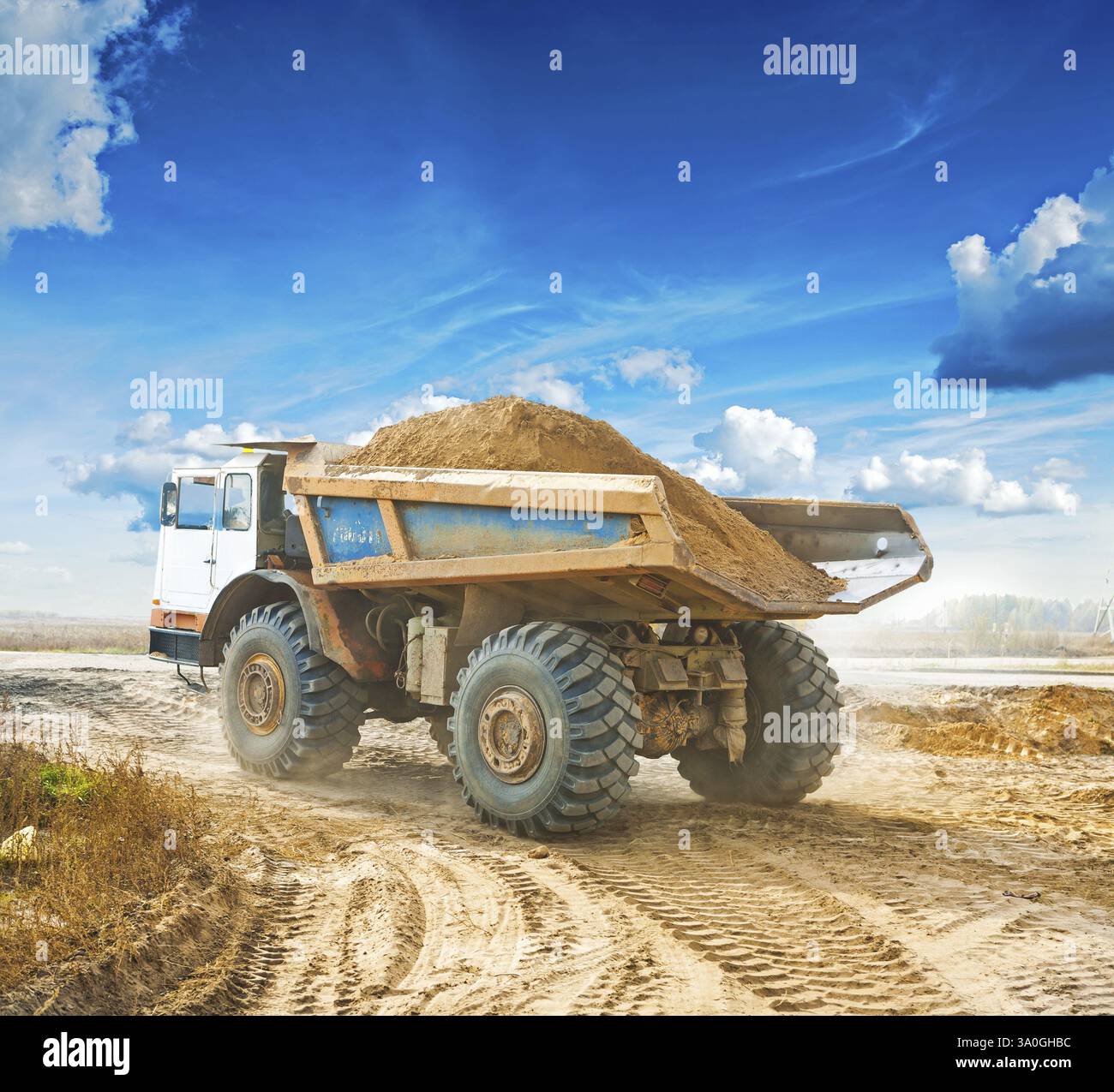 Big old roadworking tipper construction concept Stock Photo - Alamy