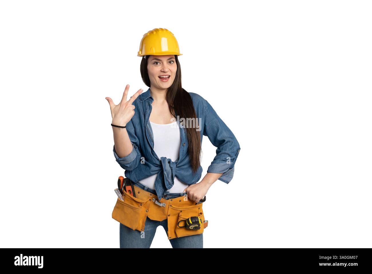 A cheerful female construction worker wearing a yellow hard hat and a ...