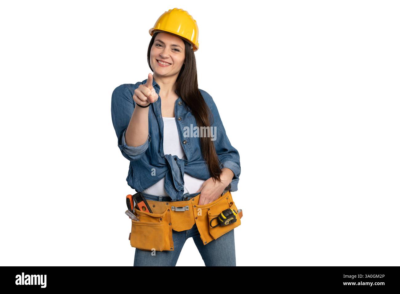 A cheerful female construction worker wearing a yellow hard hat and ...