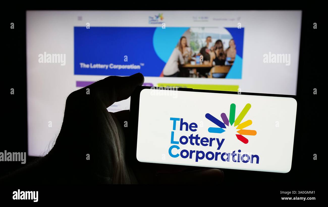 In this photo illustration, a person is holding a mobile phone with the ...