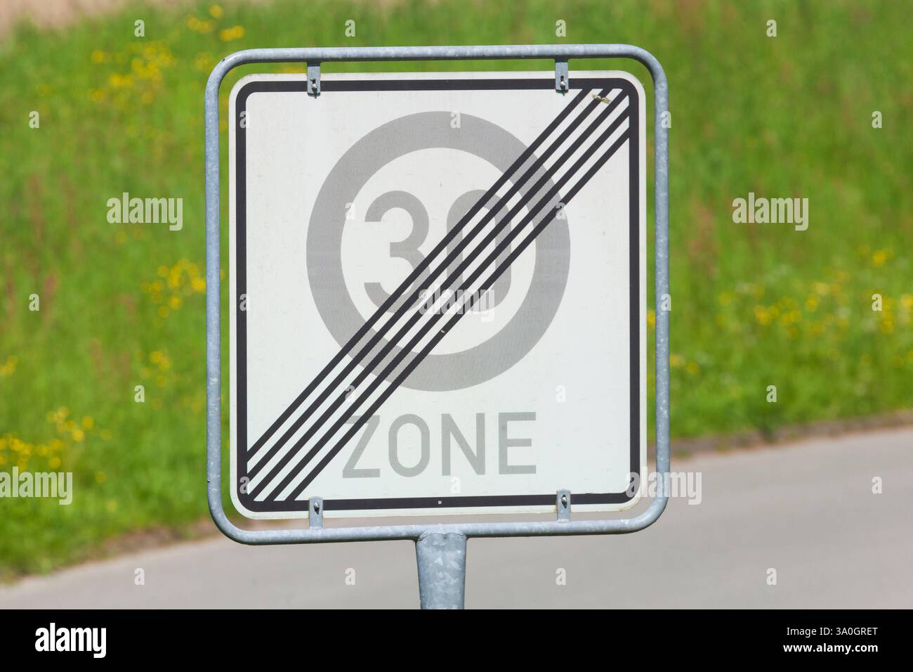 Traffic sign end of a 30 km/h zone and road in the countryside with dike in the green, Buxtehude ...