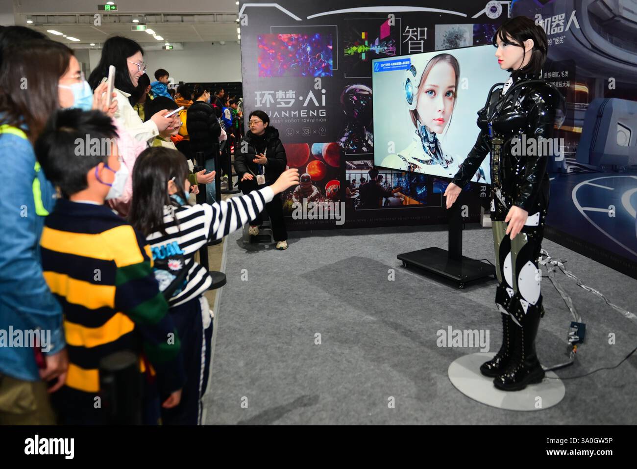 People visit an AI robot popularization exhibition in Suzhou City, east ...