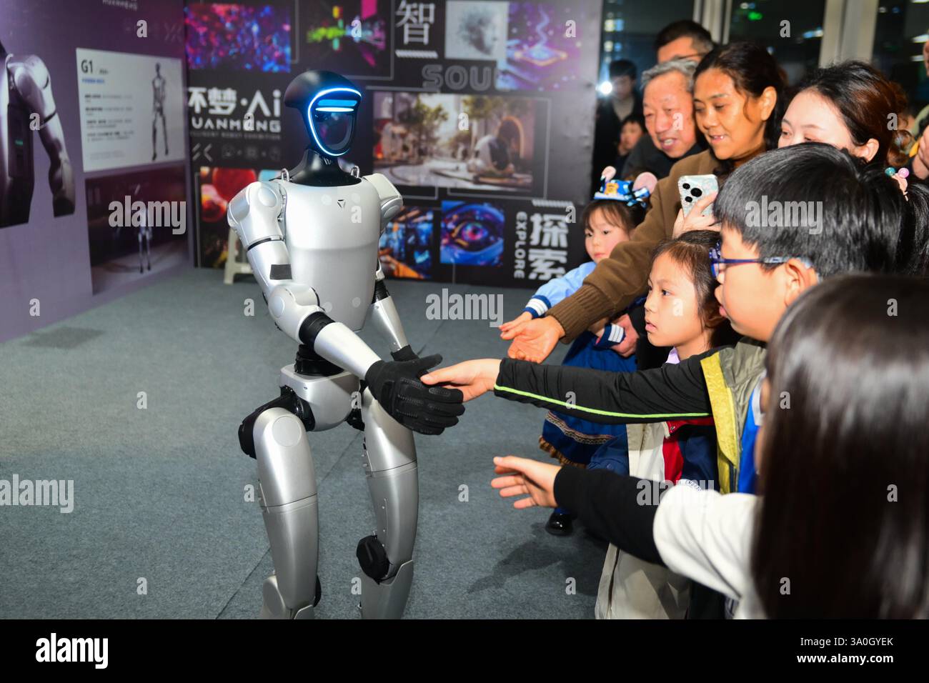 People visit an AI robot popularization exhibition in Suzhou City, east ...