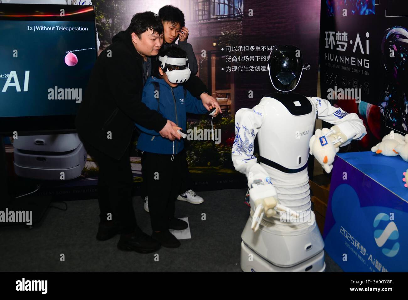 People visit an AI robot popularization exhibition in Suzhou City, east ...