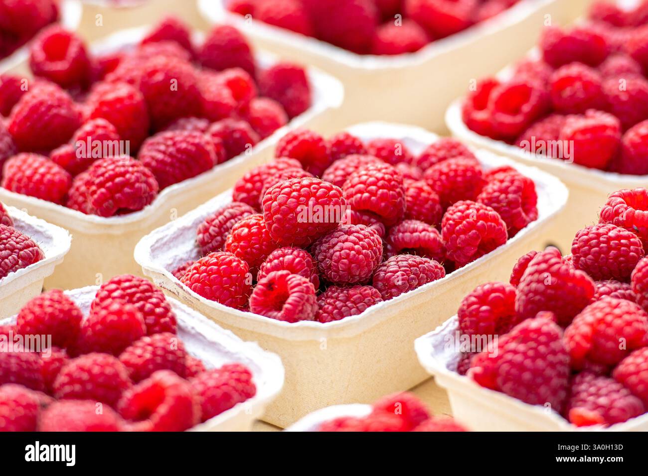Red raspberries in small baskets in a street food market ready for ...