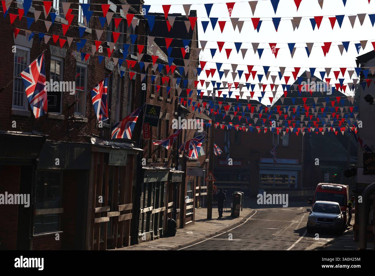 Bunting and flags adorn the High Street in Ashbourne as preparations ...