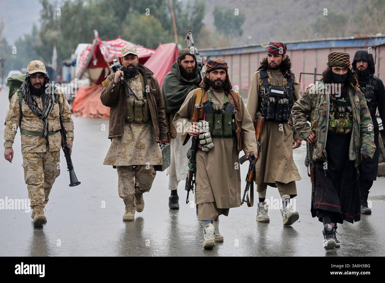 Taliban fighters patrol near the closed Torkham border with Pakistan ...