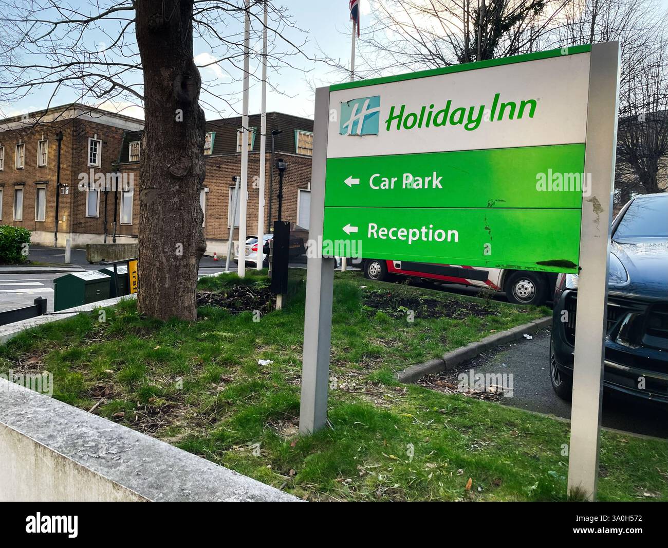 London, UK - March 02, 2025: A prominent green directional sign Holiday ...