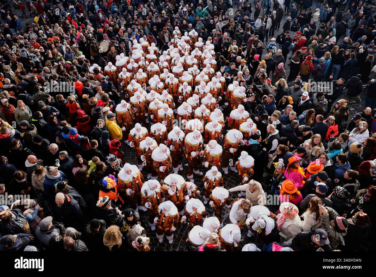 The Gilles of Binche wear their traditional wax masks as they attend ...