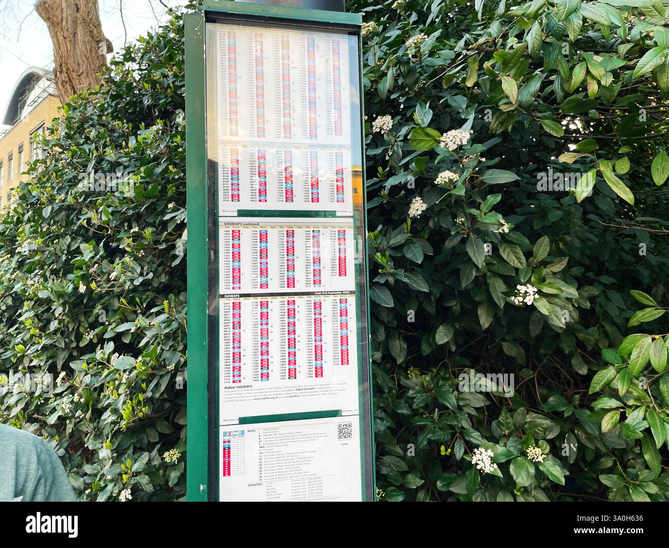 London, UK - March 02, 2025: A bus stop information station against a ...