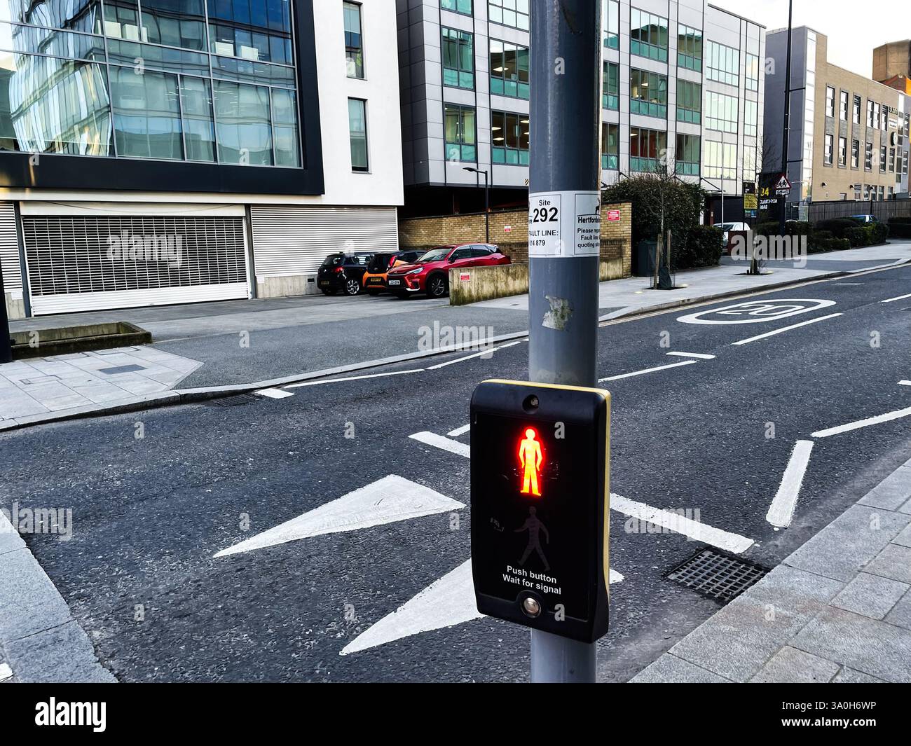 London, UK - March 02, 2025: Pedestrian crosswalk button with urban ...