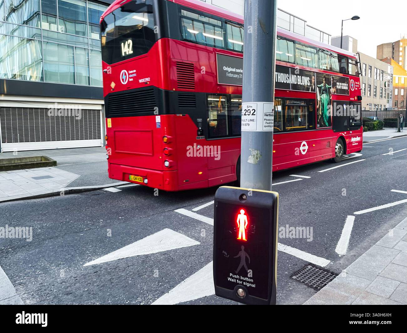 London, UK - March 02, 2025: A red double decker bus passing through a ...