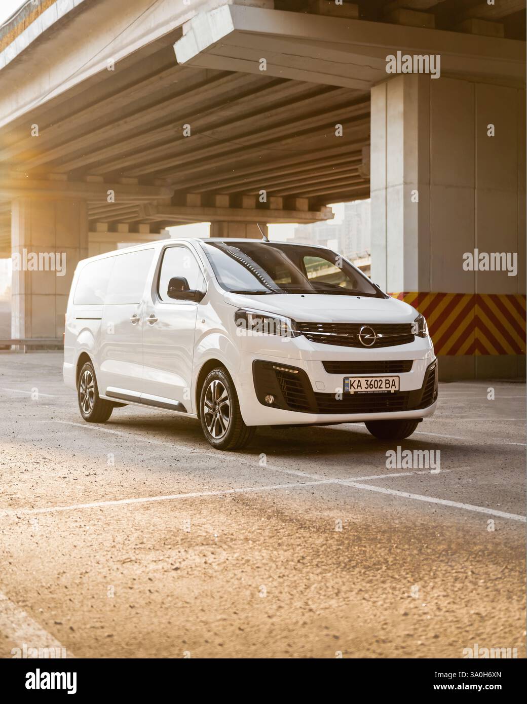 White Opel Vivaro under highway interchange. Front three quarter view ...