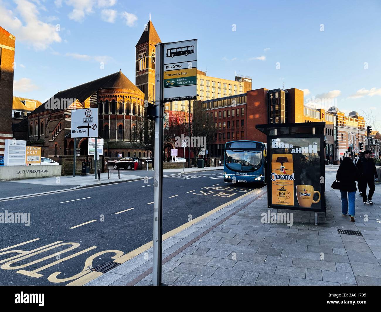 London, UK - March 02, 2025: Modern bus stop near a historic ...