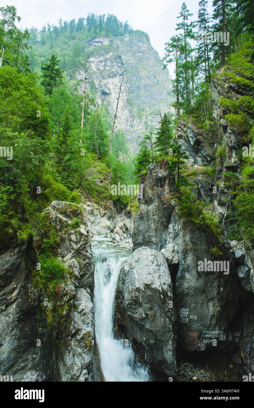 This image captures a small but vibrant waterfall cascading between ...
