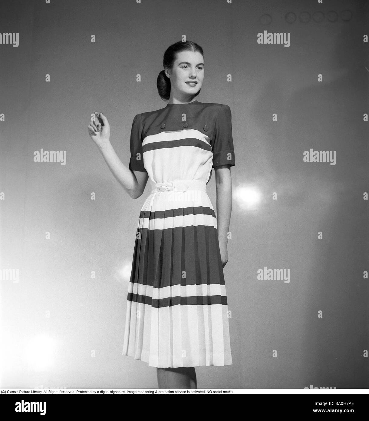 Fashion of 1946. A young female model dressed in the fashion of the ...