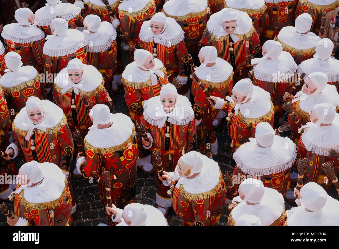 The Gilles of Binche wear their traditional wax masks as they attend ...